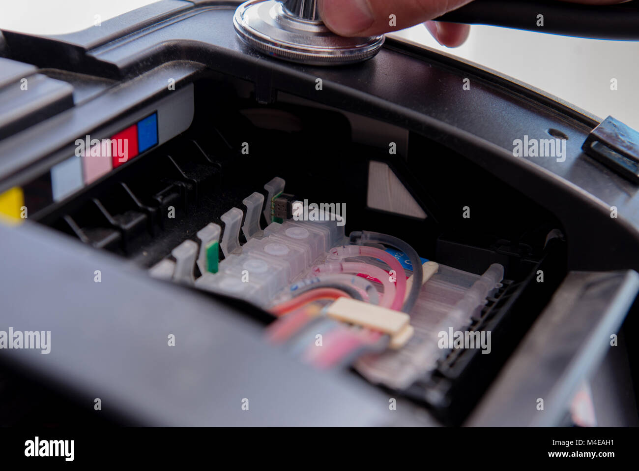 Repairman repairing broken color printer Stock Photo - Alamy