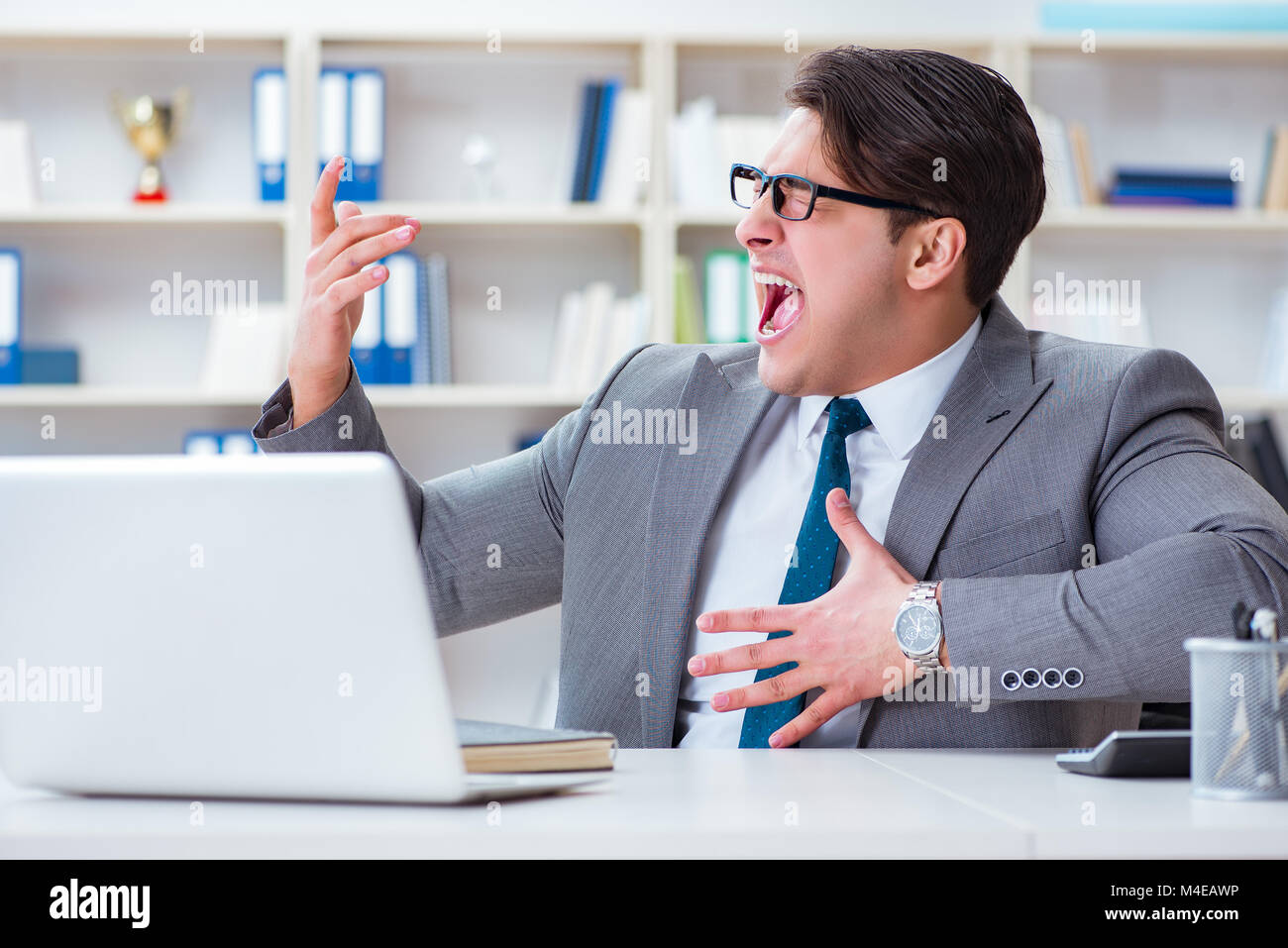 Businessman playing virtual guitar in office Stock Photo - Alamy