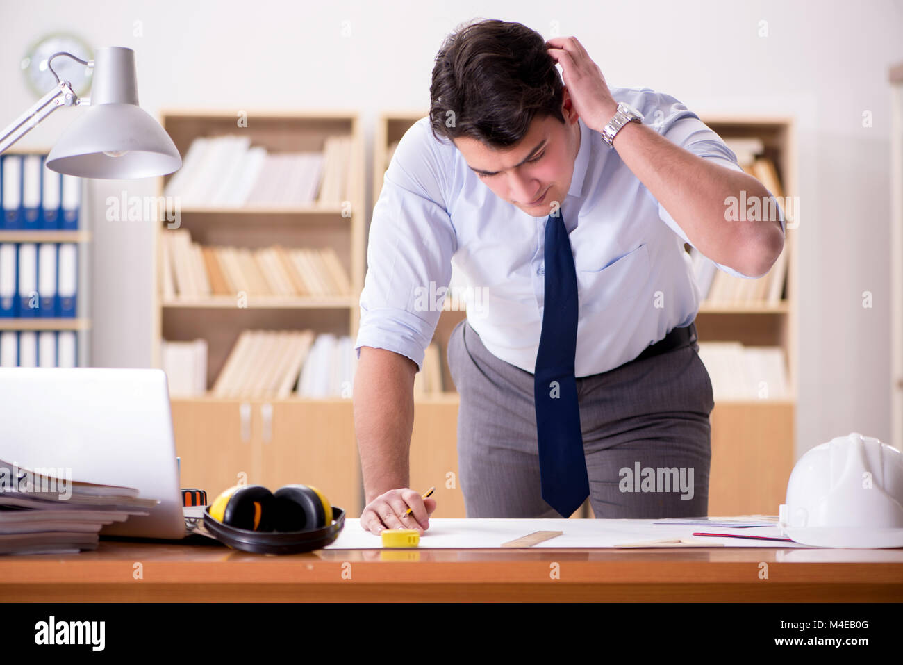 Engineer supervisor working on drawings in the office Stock Photo - Alamy