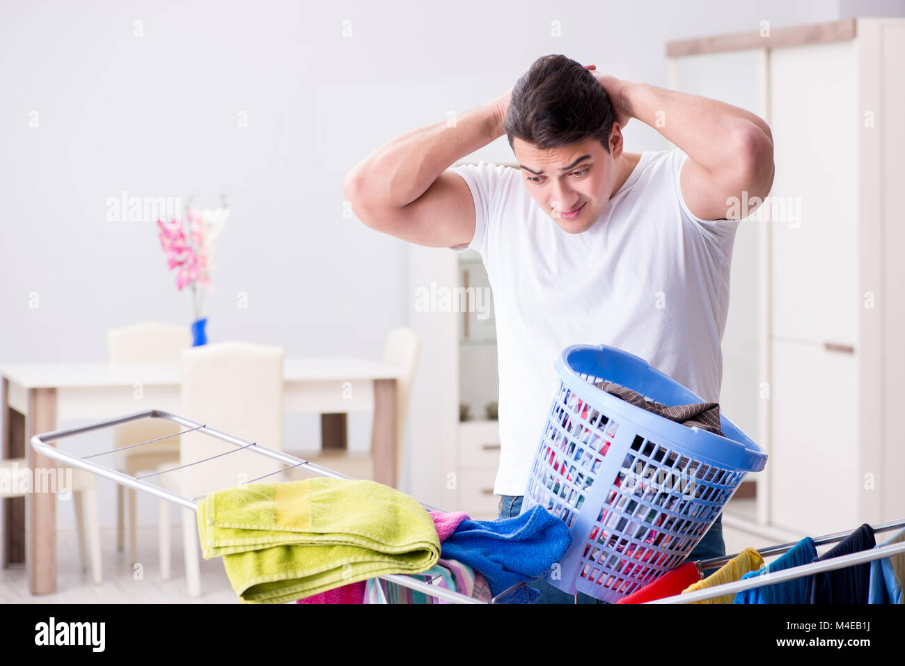 Man doing laundry at home Stock Photo - Alamy