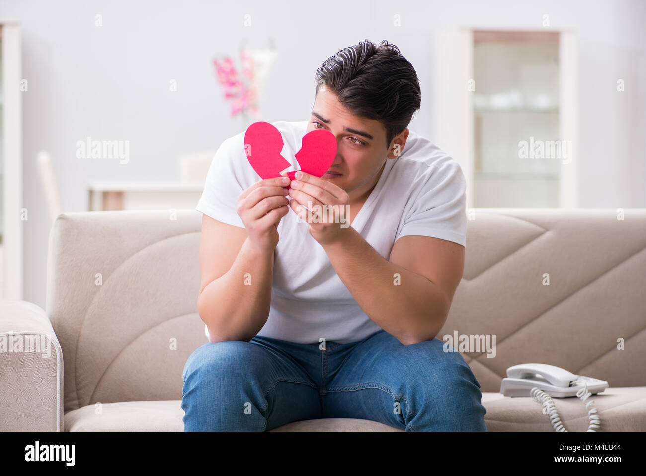 Young man in sad saint valentine concept Stock Photo - Alamy