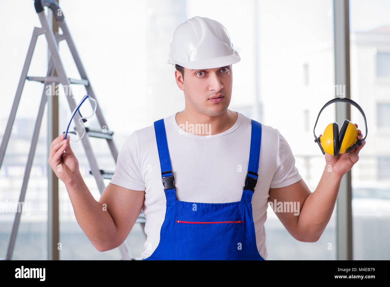 Young worker with noise cancelling headphones Stock Photo - Alamy