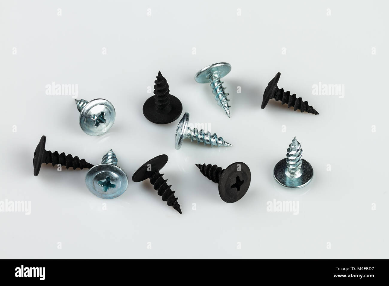 silver chrom and black anodized screws on white background Stock Photo ...
