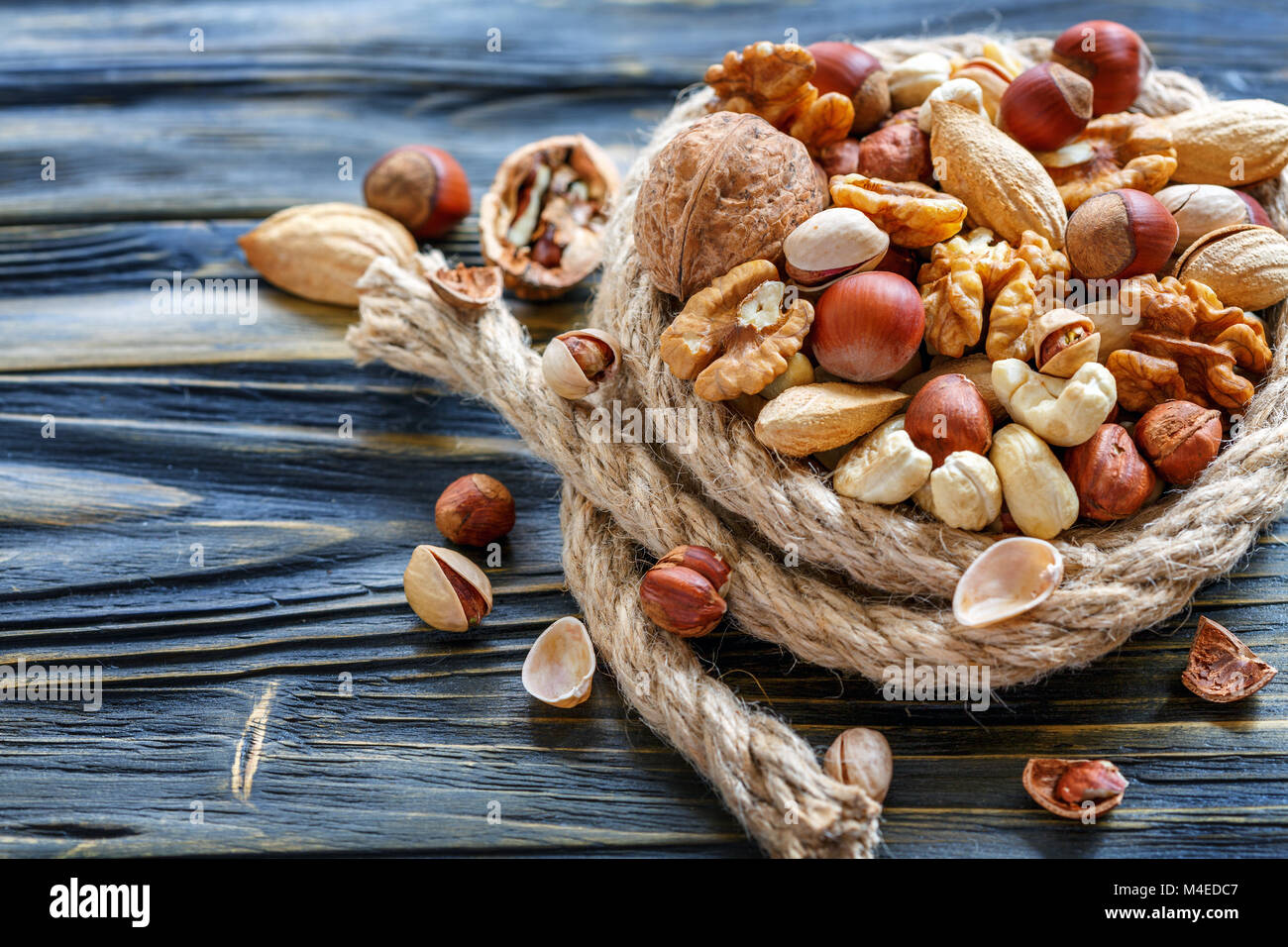 Hemp rope and a mixed of nuts Stock Photo - Alamy