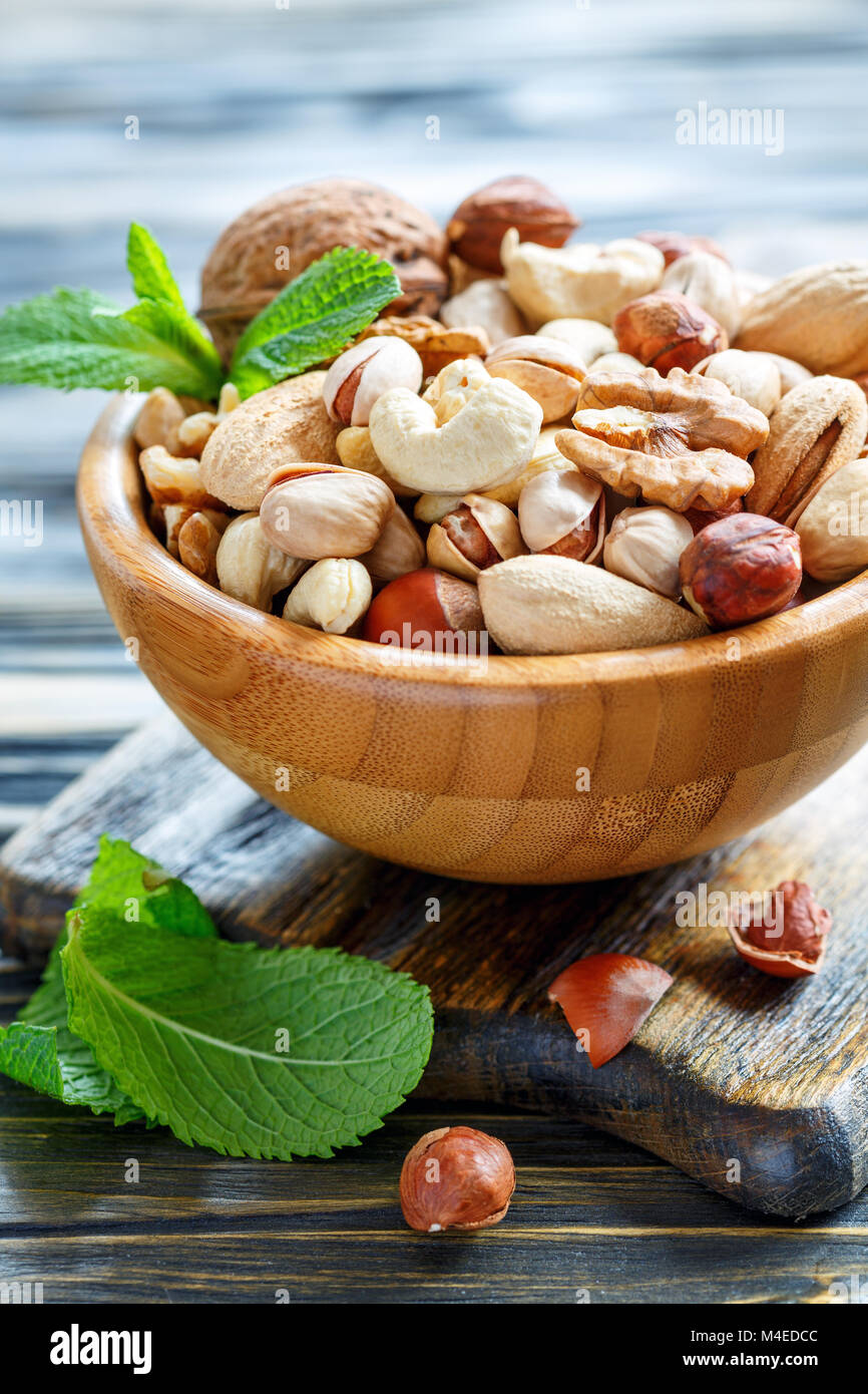 Mixed nuts in a wooden bowl Stock Photo - Alamy