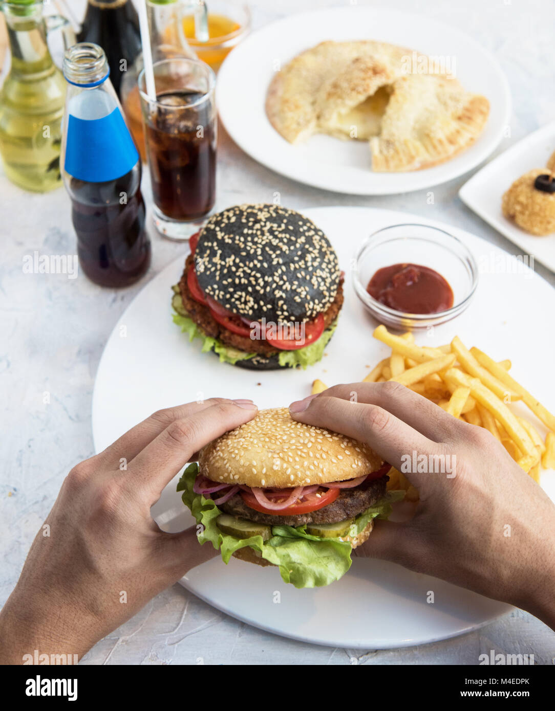 Man eating burgers Stock Photo - Alamy