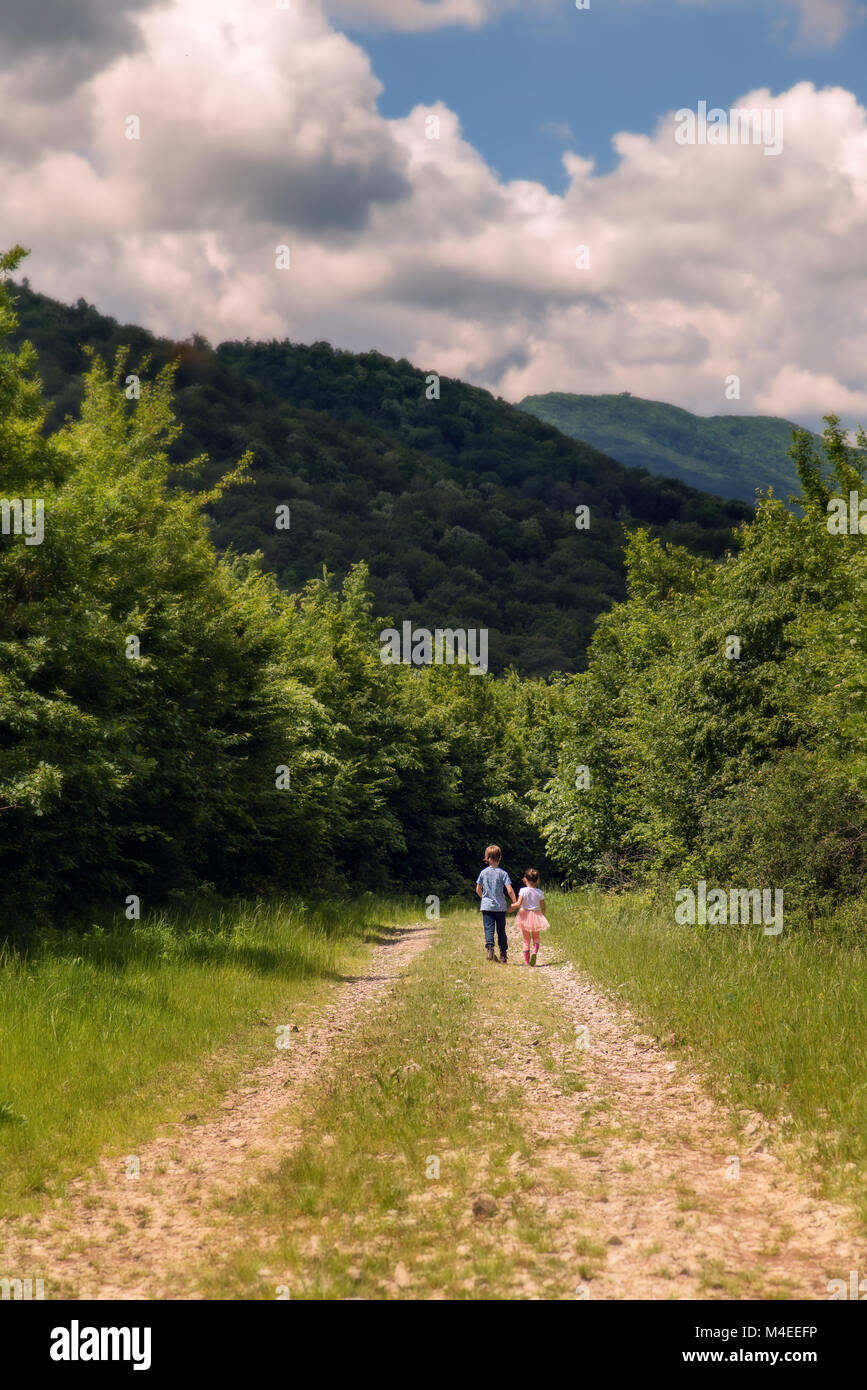 Boy and girl walking along a rural footpath Stock Photo - Alamy