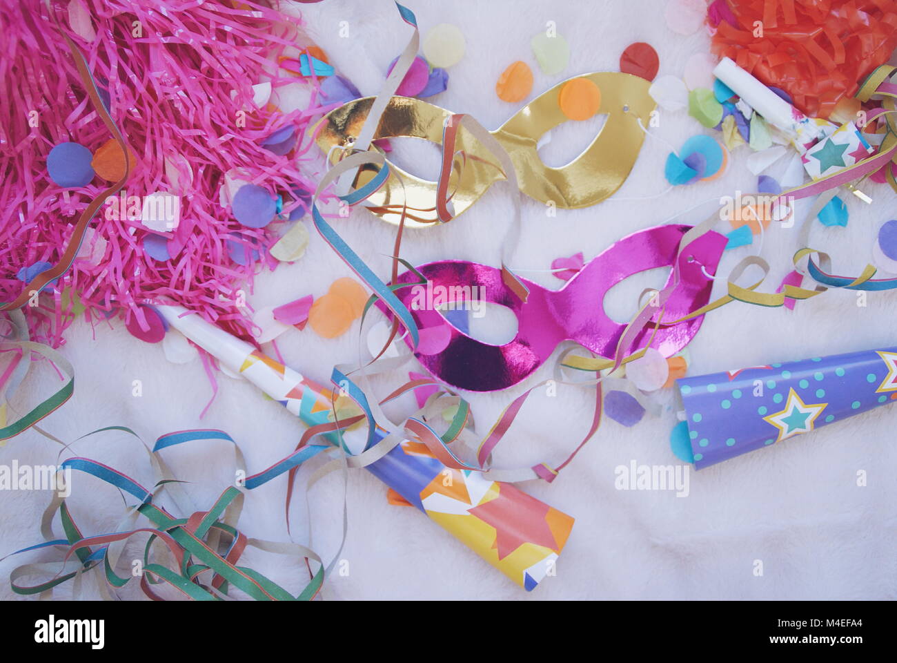 Streamers, party horns, masks and confetti Stock Photo - Alamy