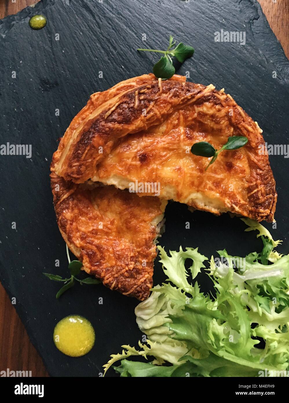 Overhead view of a meat pie with salad garnish Stock Photo - Alamy