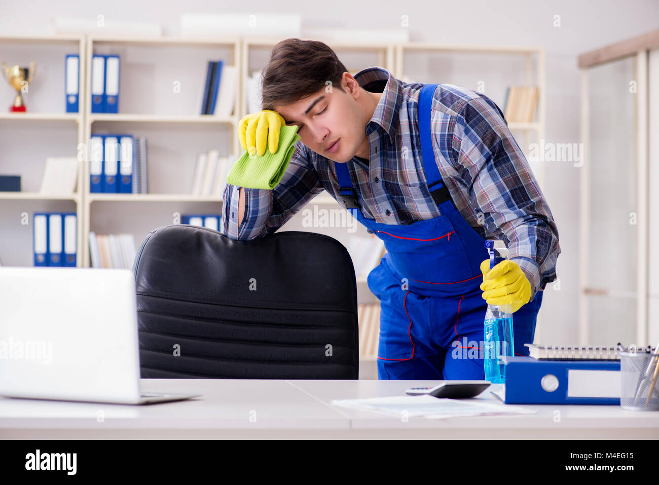 Male cleaner working in the office Stock Photo - Alamy
