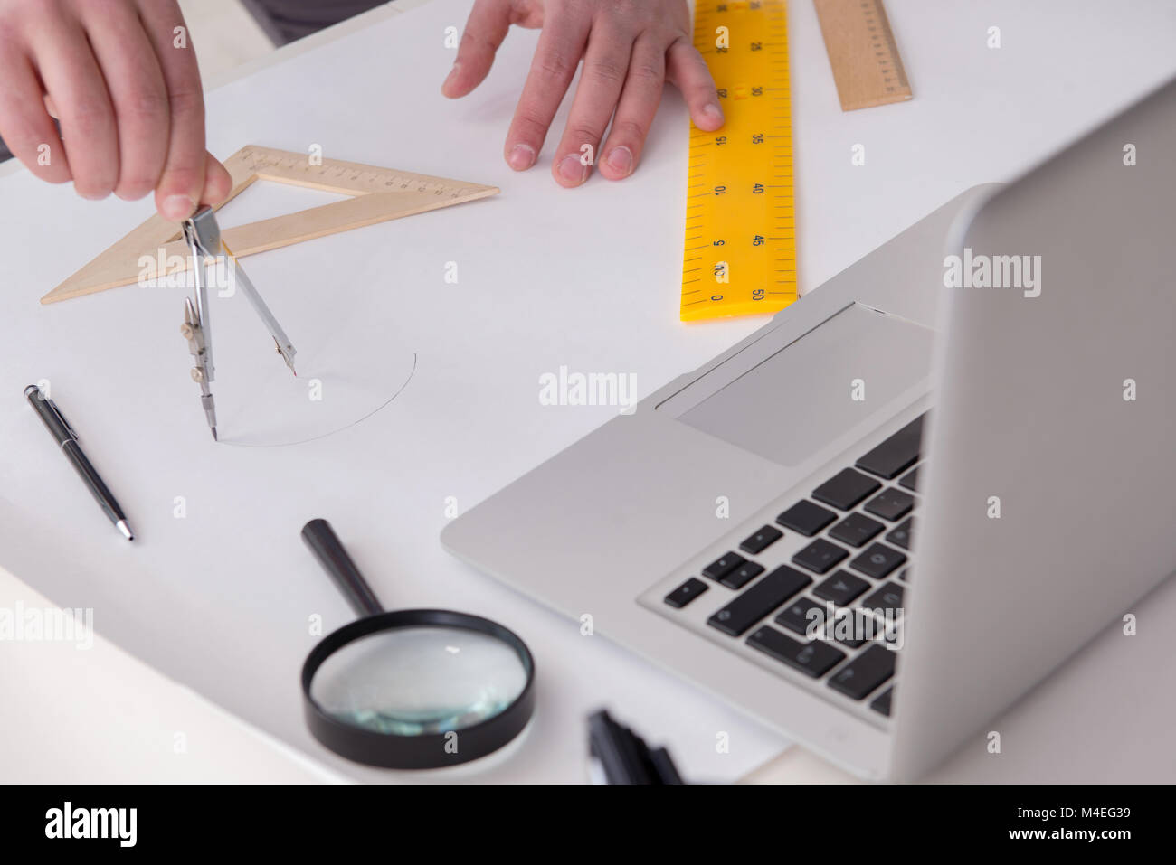Male engineer working on drawings and blueprints Stock Photo - Alamy