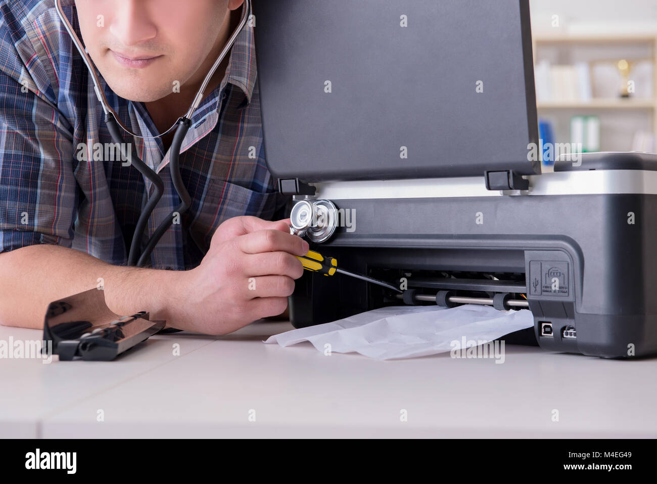 Repairman repairing broken color printer Stock Photo - Alamy