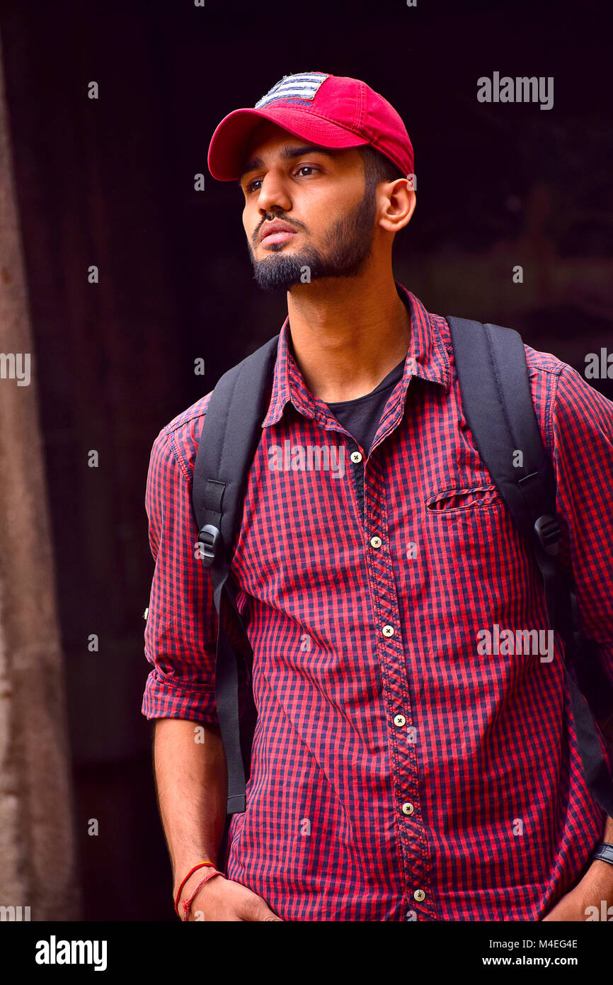 Young man with red cap and backpack, Pune, Maharashtra Stock Photo - Alamy