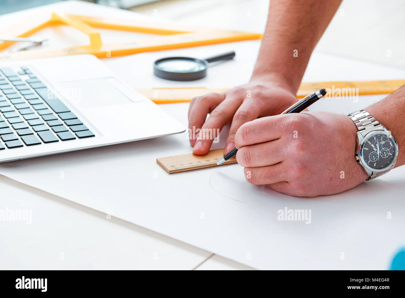 Male engineer working on drawings and blueprints Stock Photo - Alamy