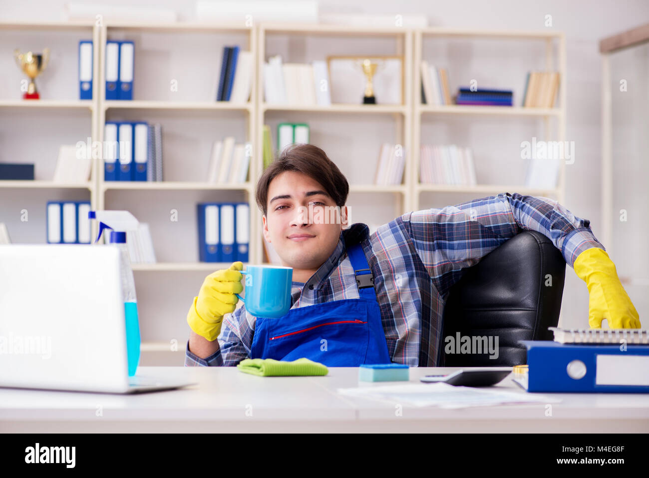 Male cleaner working in the office Stock Photo - Alamy