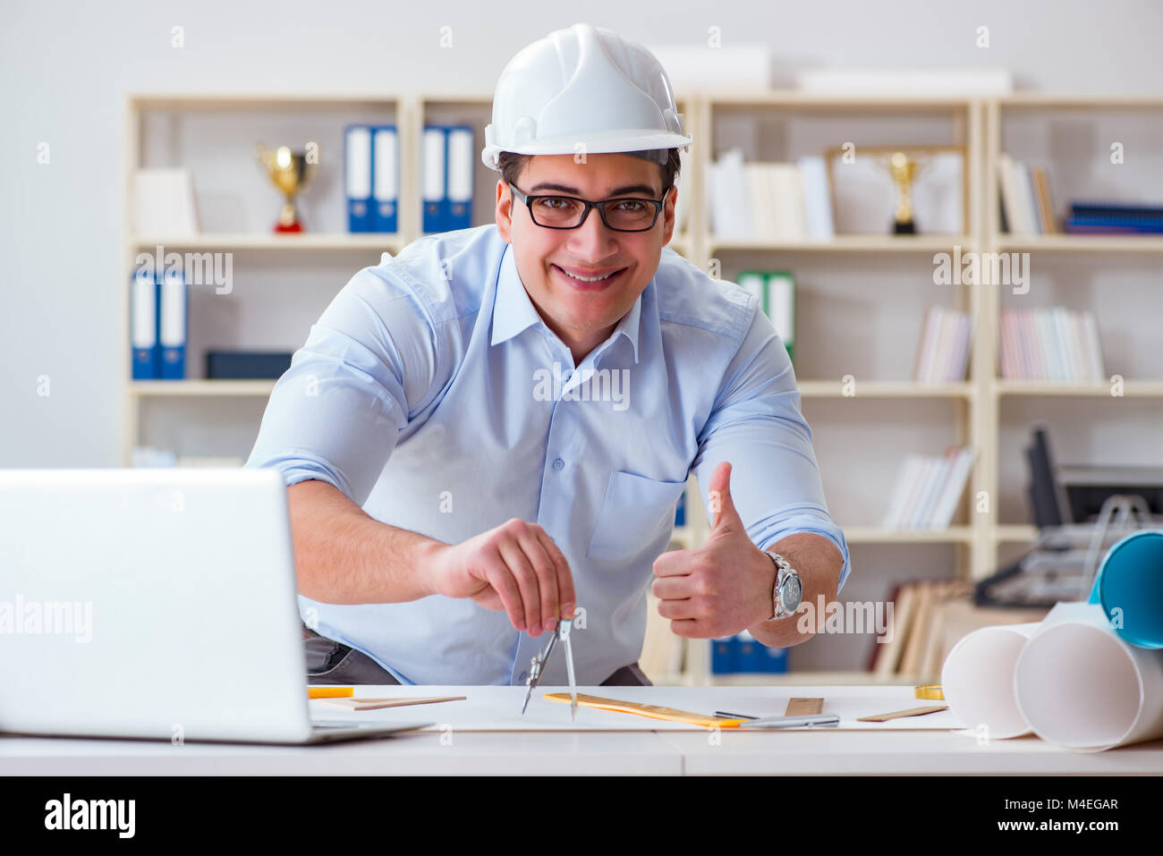 Male engineer working on drawings and blueprints Stock Photo - Alamy