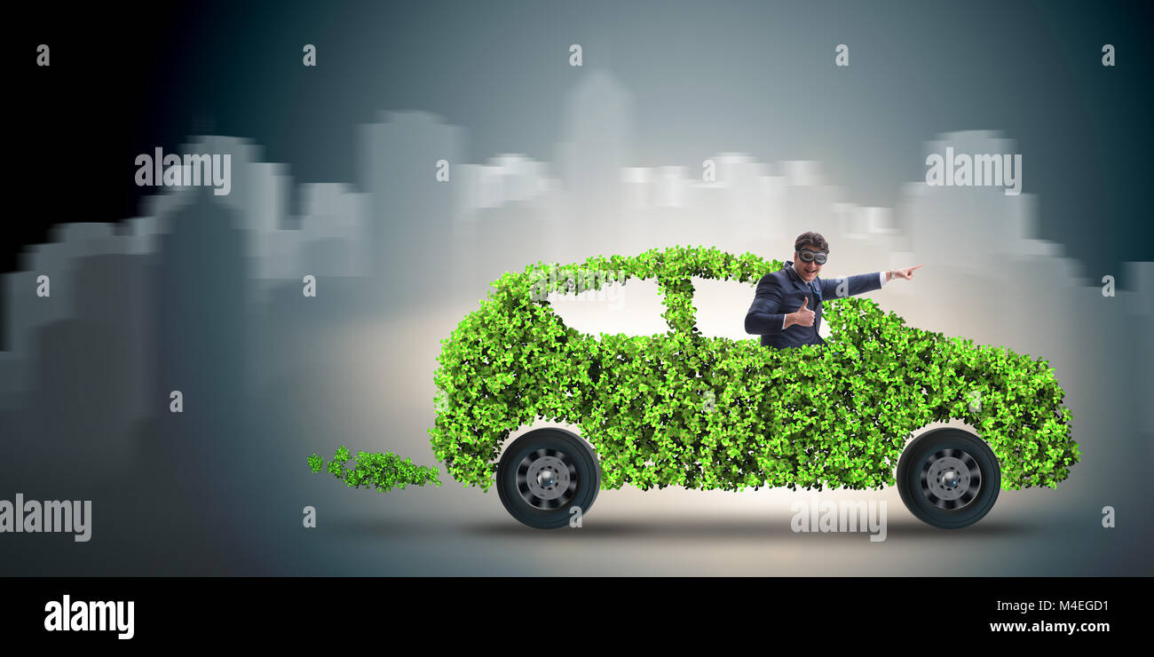 Businessman in green electric car concept Stock Photo - Alamy