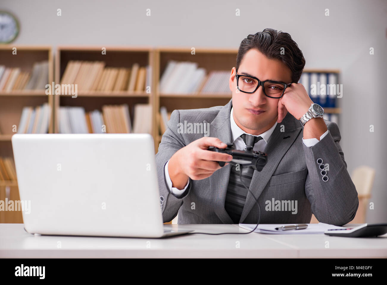 Businessman playing computer games at work office Stock Photo - Alamy