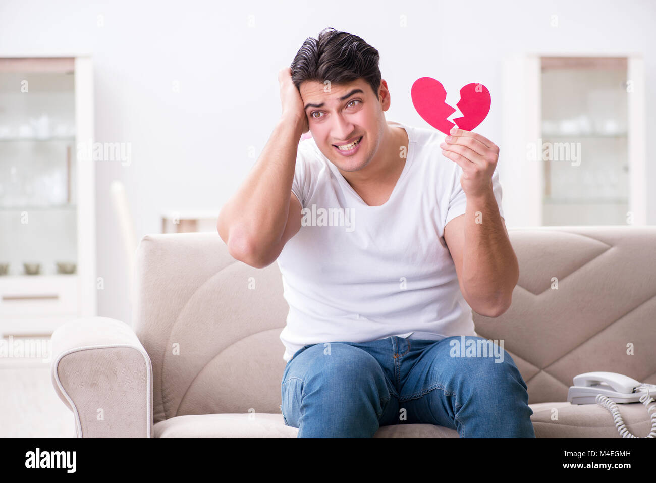 Young man in sad saint valentine concept Stock Photo - Alamy
