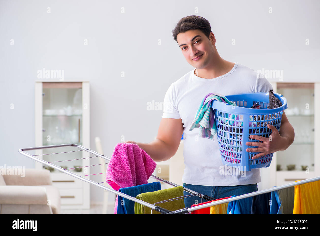 Man doing laundry at home Stock Photo - Alamy
