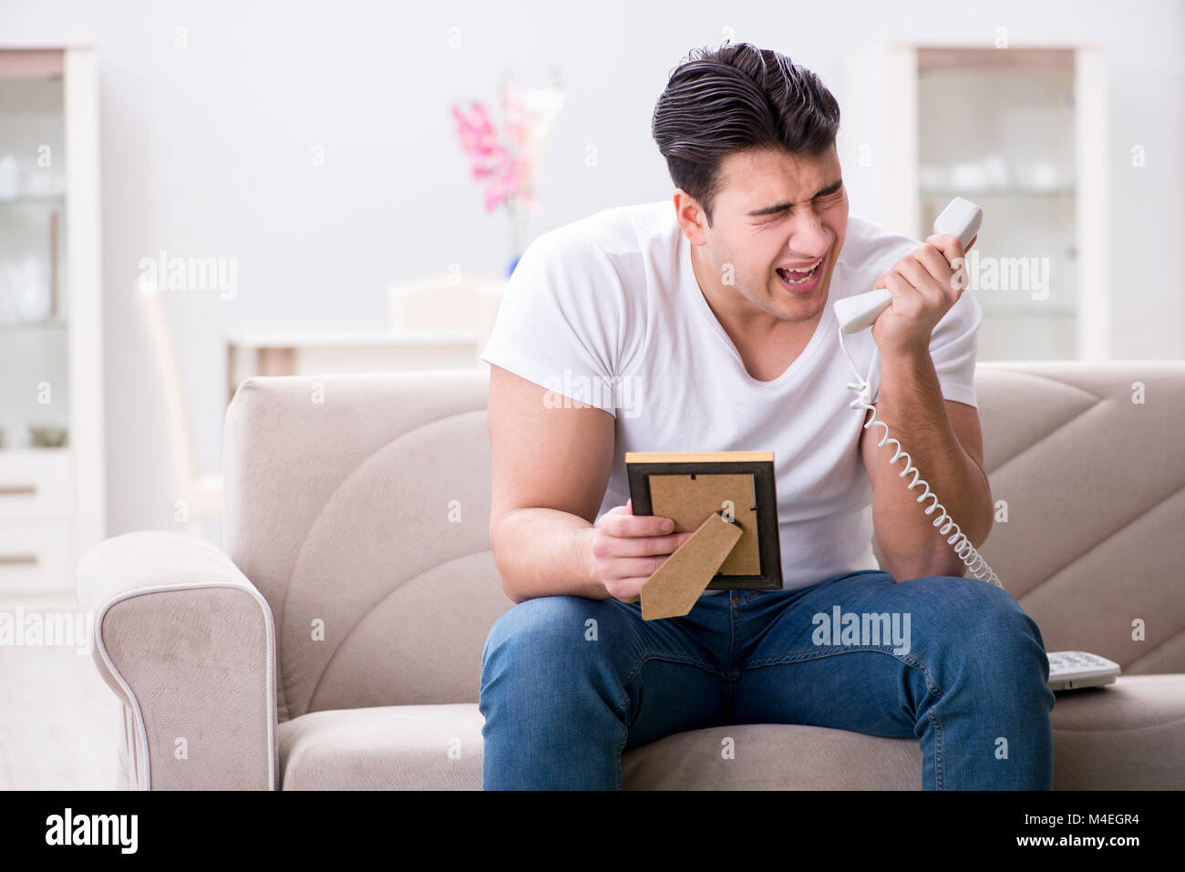 Young man in sad saint valentine concept Stock Photo - Alamy
