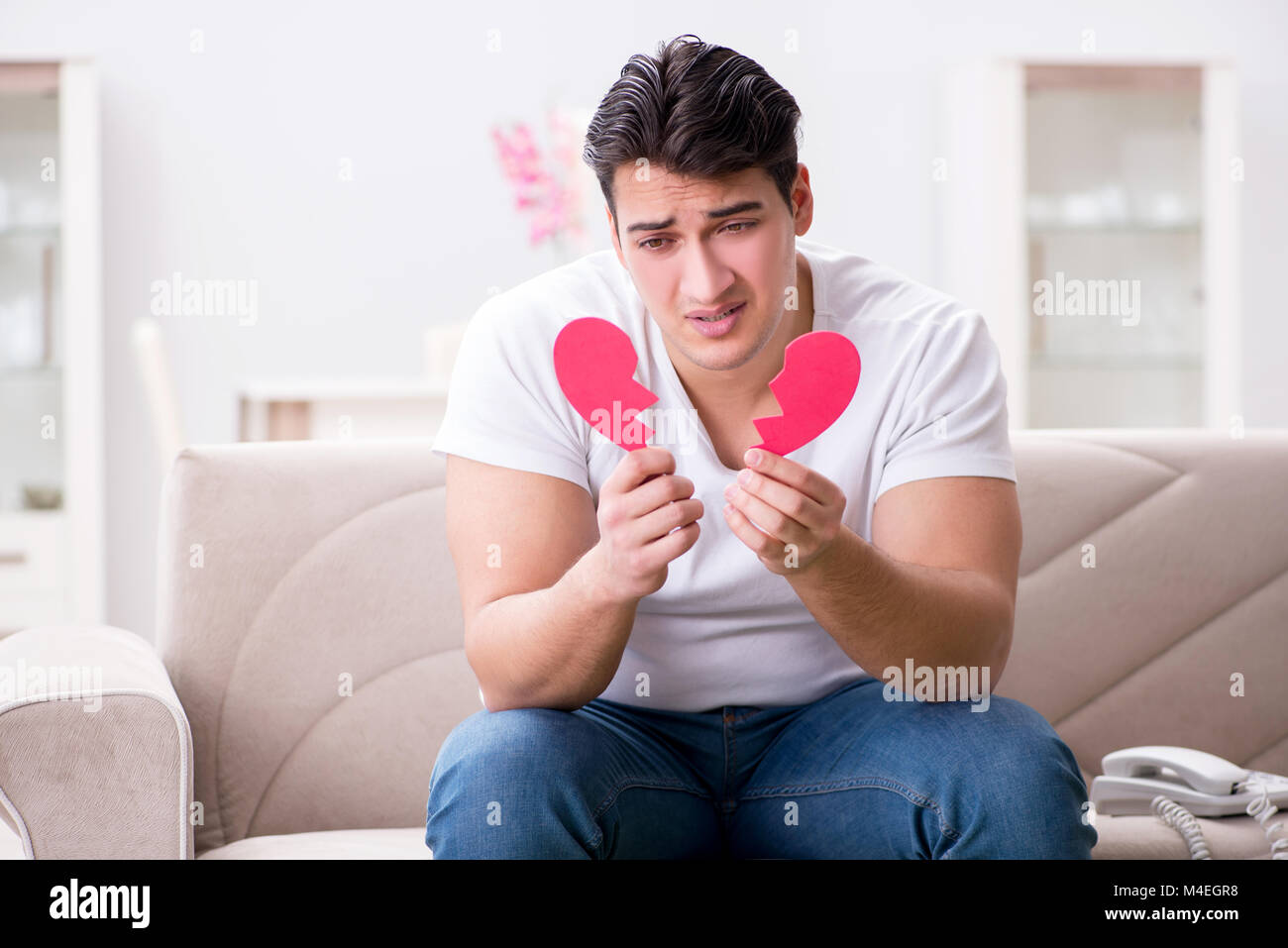 Young man in sad saint valentine concept Stock Photo - Alamy