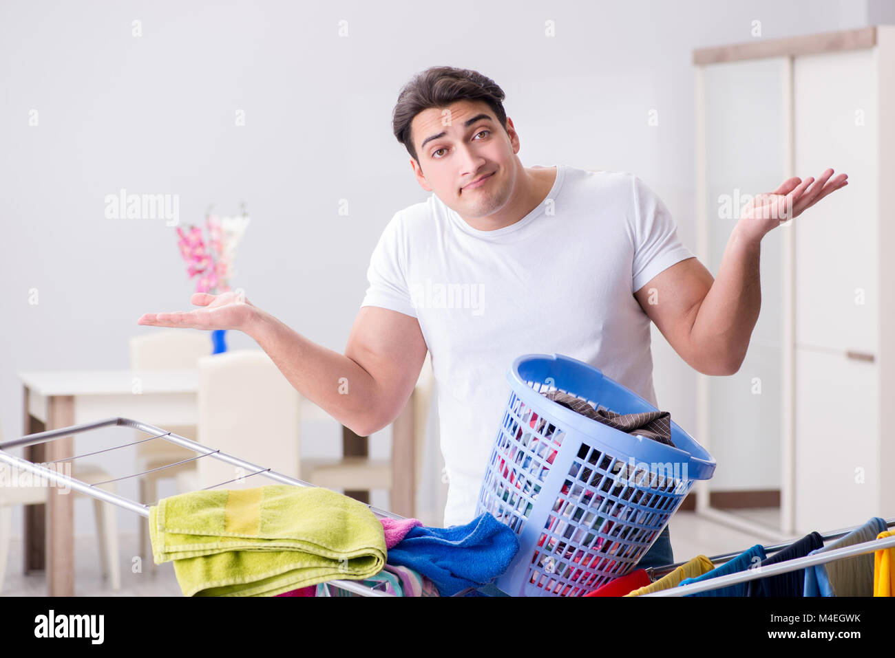 Man doing laundry at home Stock Photo - Alamy