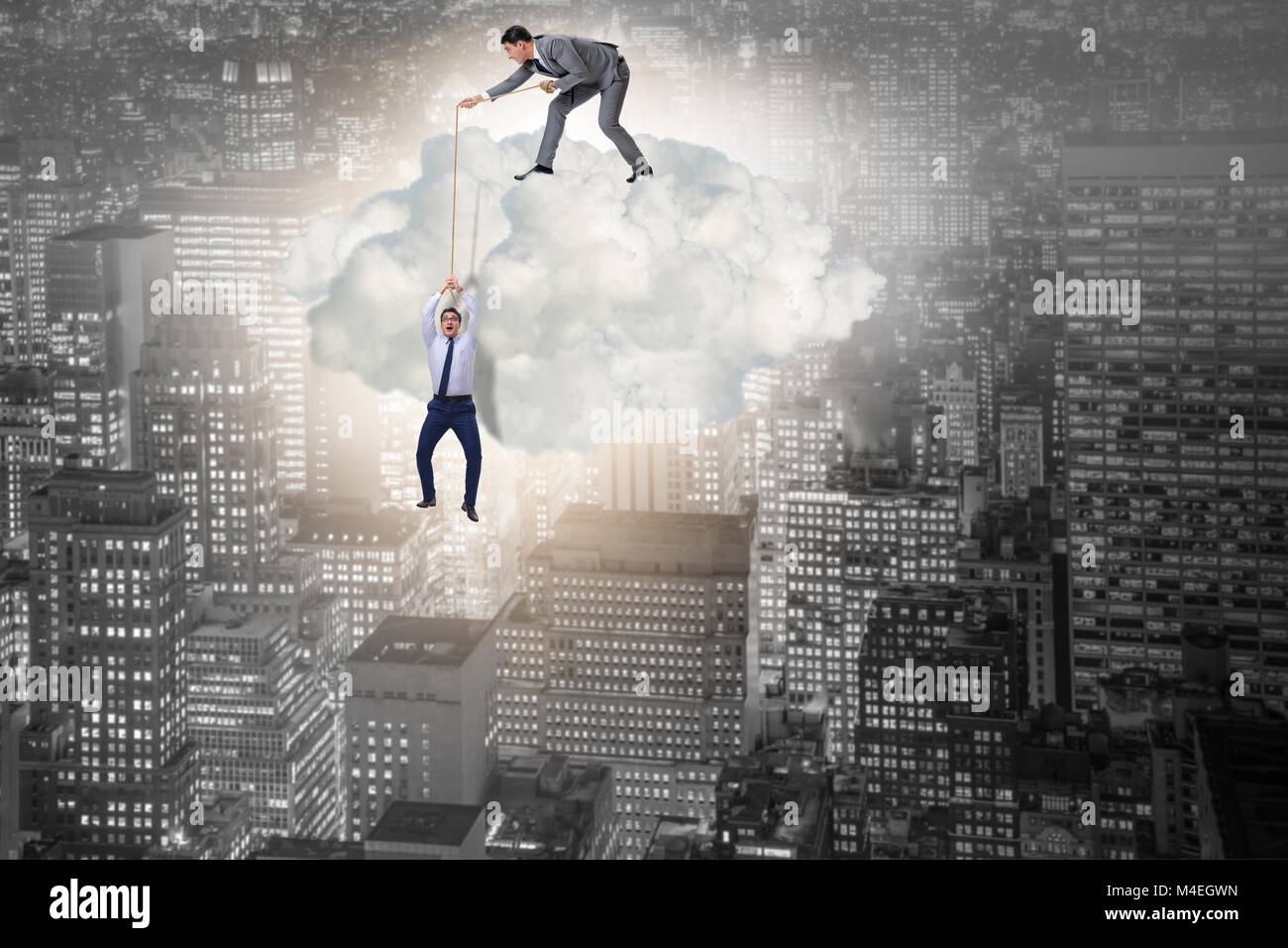 Businessman saving colleague by pulling rope Stock Photo - Alamy