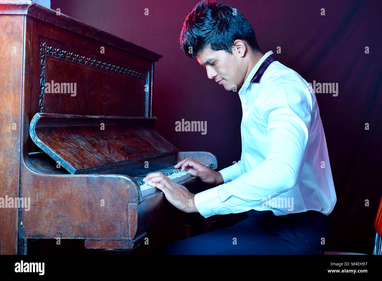 Man playing old vintage piano, Pune, Maharashtra Stock Photo - Alamy