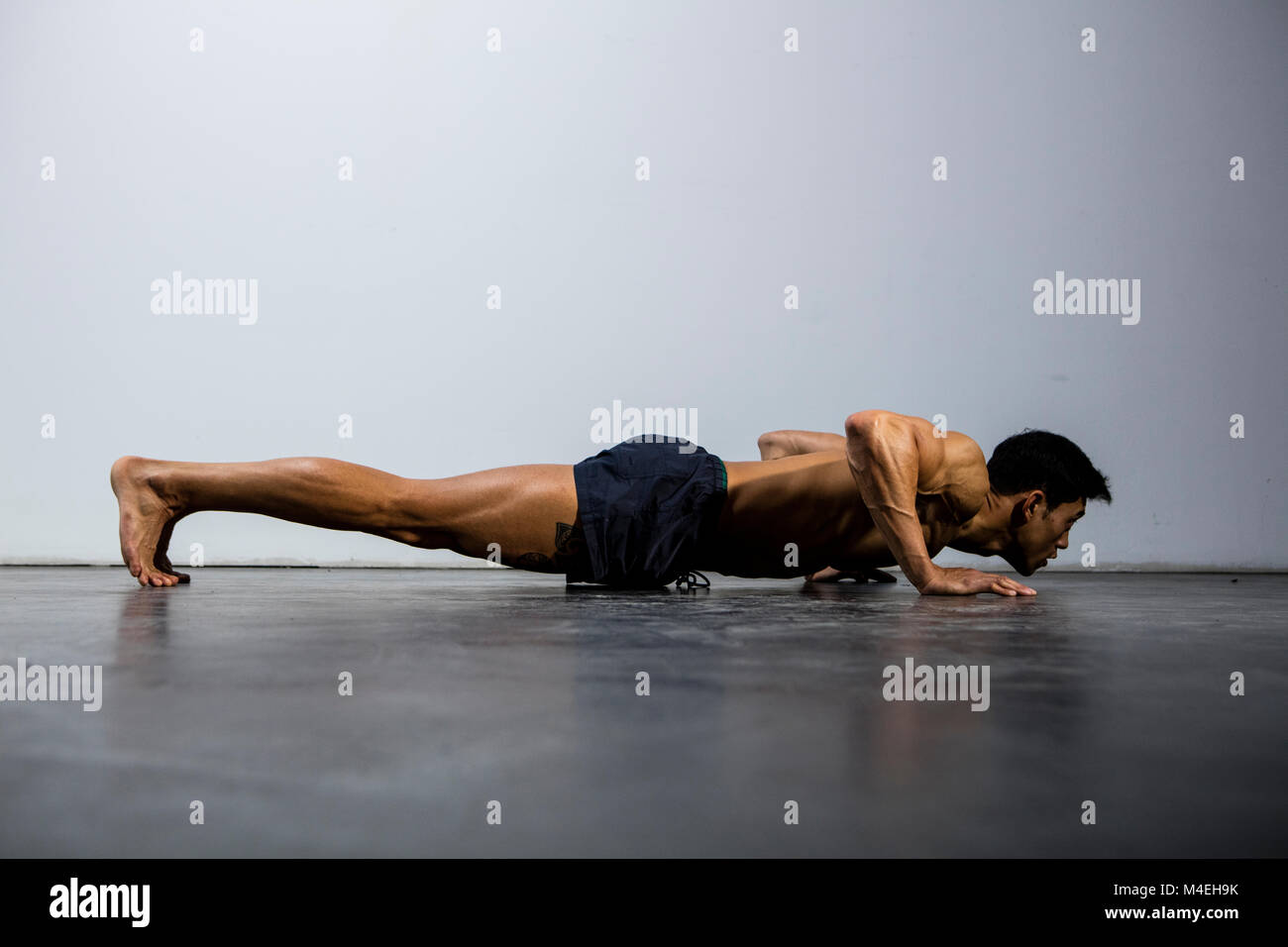 Fitness model performing push up exercise. Profile Stock Photo - Alamy