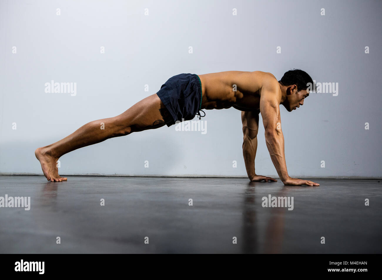 Fitness model performing push up exercise. Profile Stock Photo - Alamy