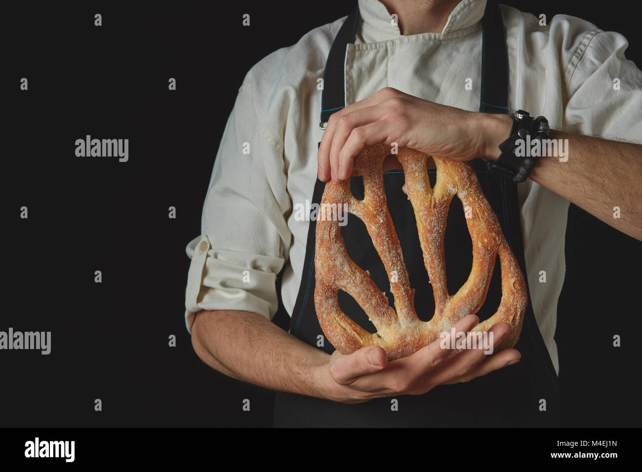 Hands men holding fougas bread Stock Photo - Alamy