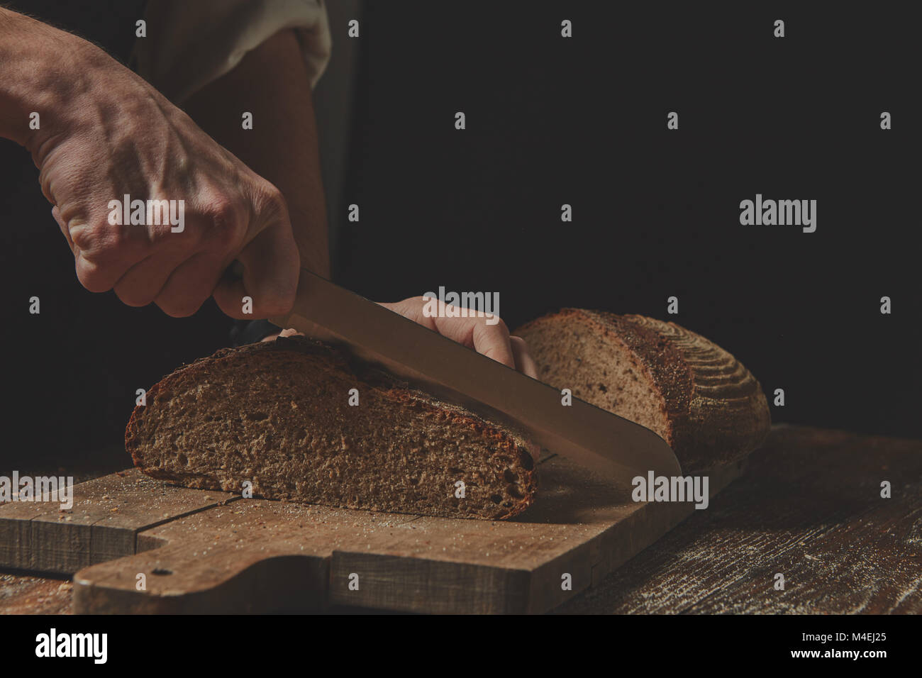 Man cutting bread hi-res stock photography and images - Alamy