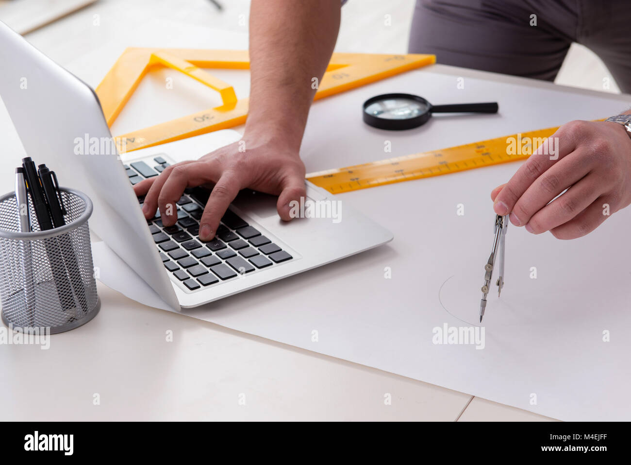 Male engineer working on drawings and blueprints Stock Photo - Alamy