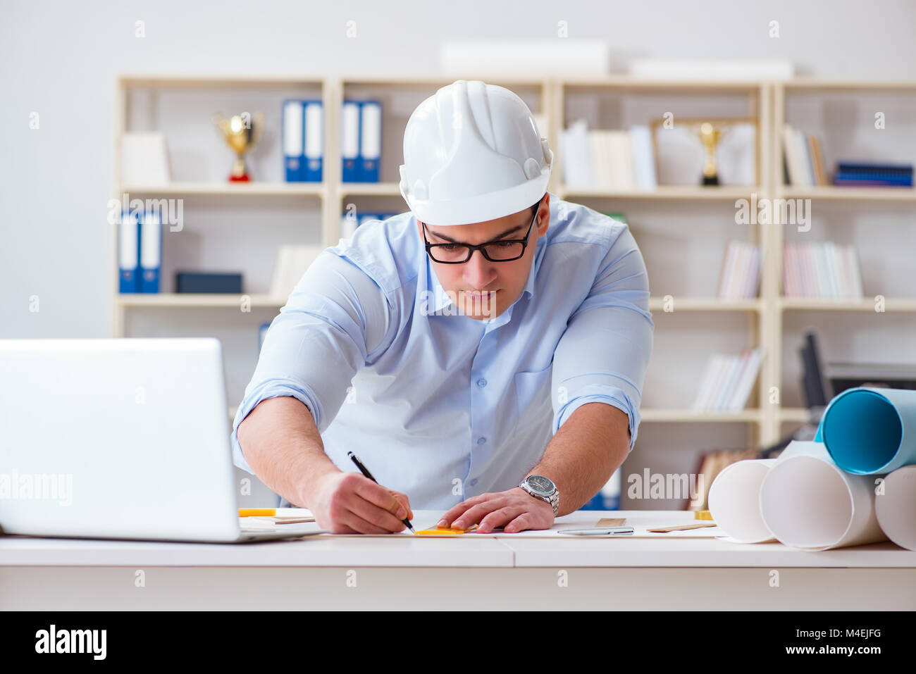 Male engineer working on drawings and blueprints Stock Photo - Alamy