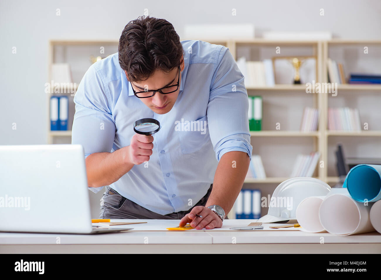 Male engineer working on drawings and blueprints Stock Photo - Alamy