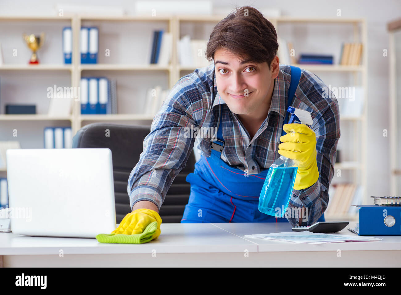 Cleaner man cleaning the office Stock Photo - Alamy