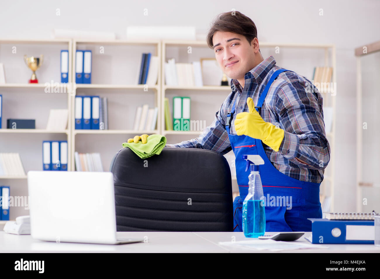 Male cleaner working in the office Stock Photo - Alamy