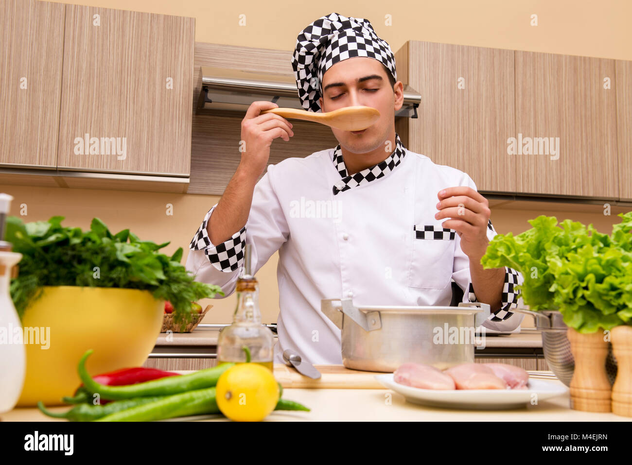 Young chef working in the kitchen Stock Photo - Alamy