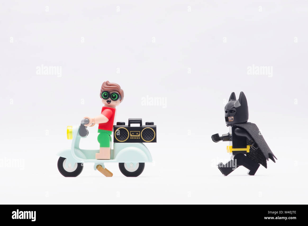 lego batman chasing robin riding a scooter. isolated on white ...