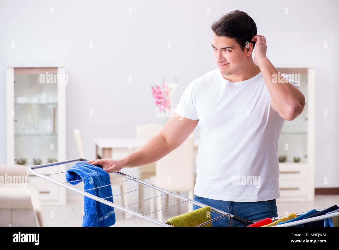Man doing laundry at home Stock Photo - Alamy