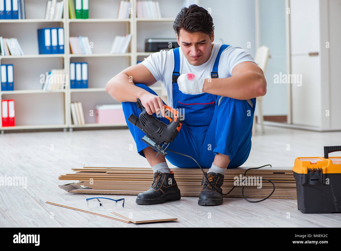 Young worker working on floor laminate tiles Stock Photo - Alamy