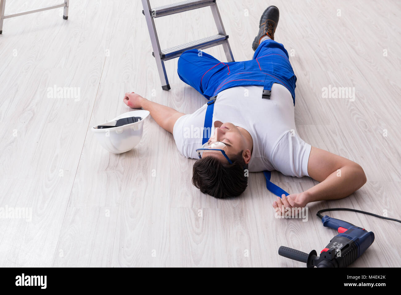 Worker after falling from height - unsafe behavior Stock Photo - Alamy