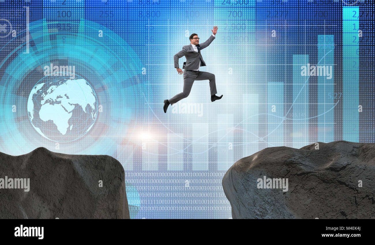 Ambitious businessman jumping over the cliff Stock Photo - Alamy