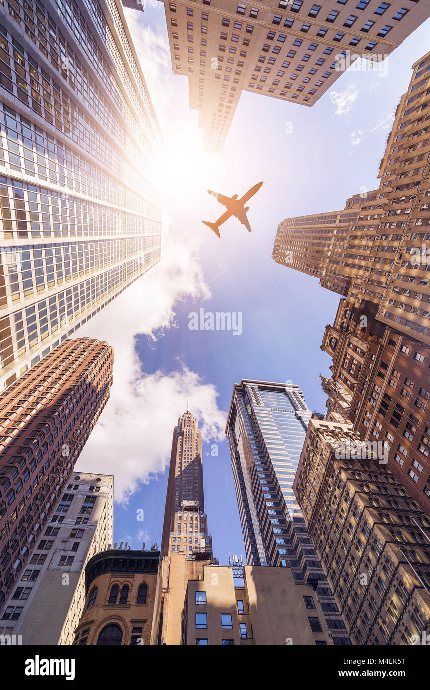 plane over highrise buildings Stock Photo - Alamy