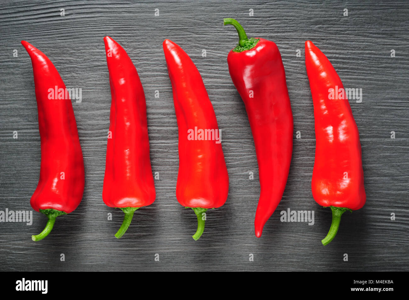 Sweet red Kapia peppers on a dark shale stone background Stock Photo ...