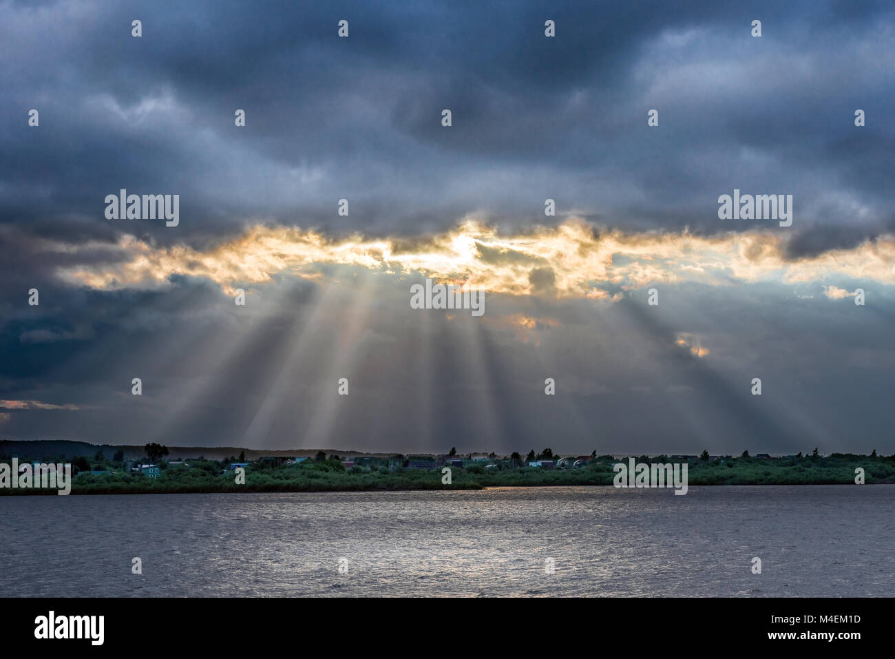 Sun rays through storm clouds hi-res stock photography and images - Alamy