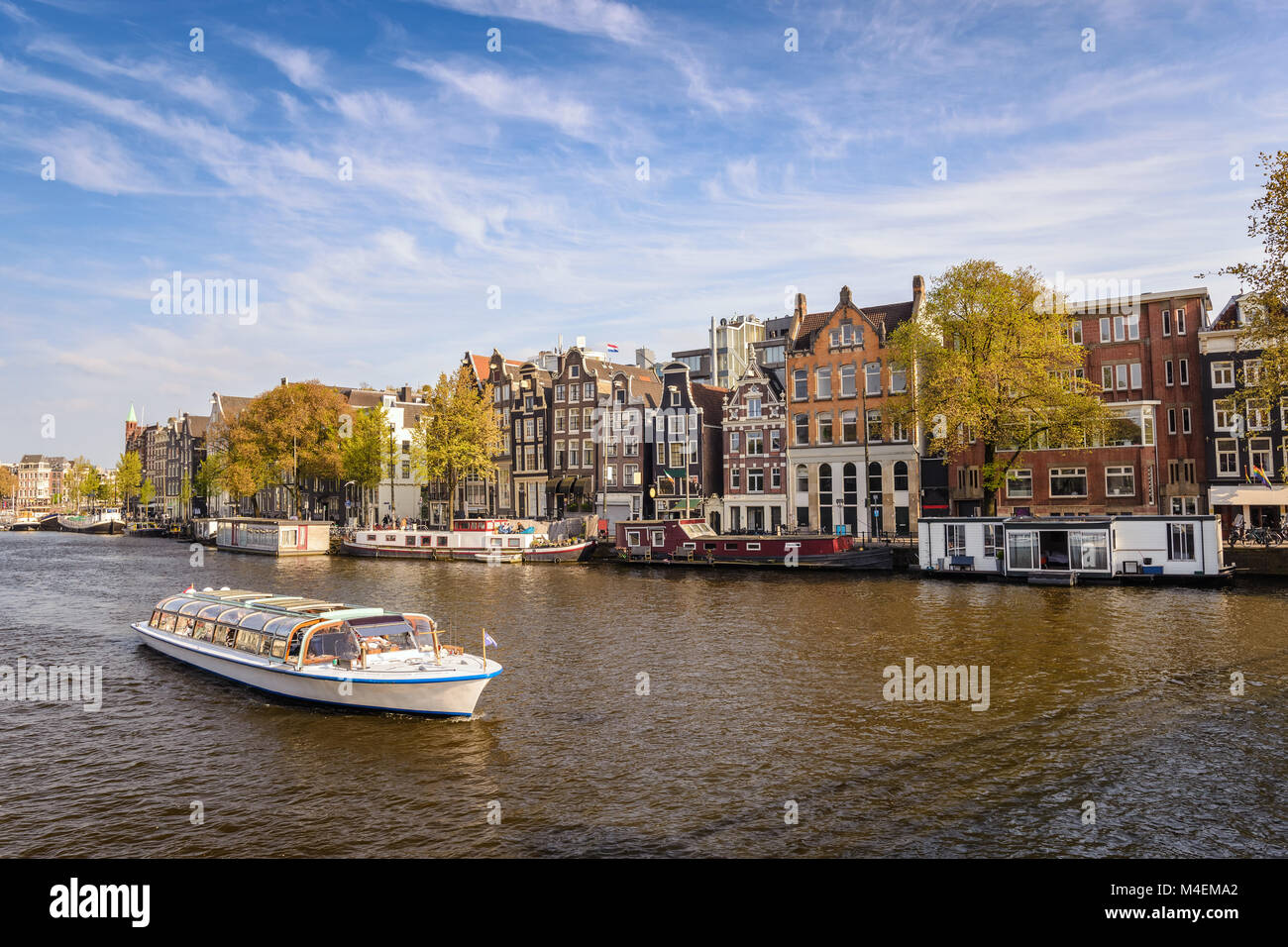 Amsterdam city skyline at canal waterfront, Amsterdam, Netherlands ...