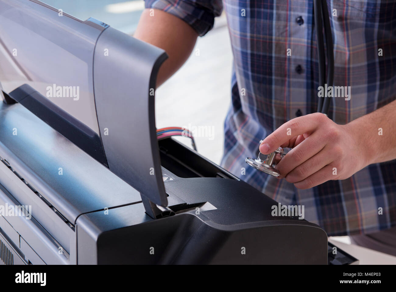 Repairman repairing broken color printer Stock Photo - Alamy
