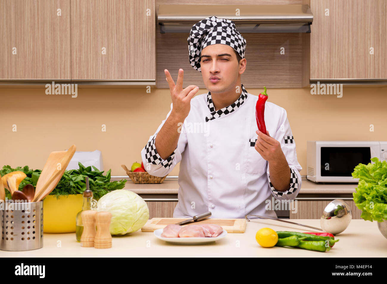Young chef working in the kitchen Stock Photo - Alamy